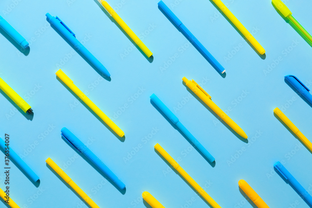 Pens and markers on color background Stock Photo | Adobe Stock