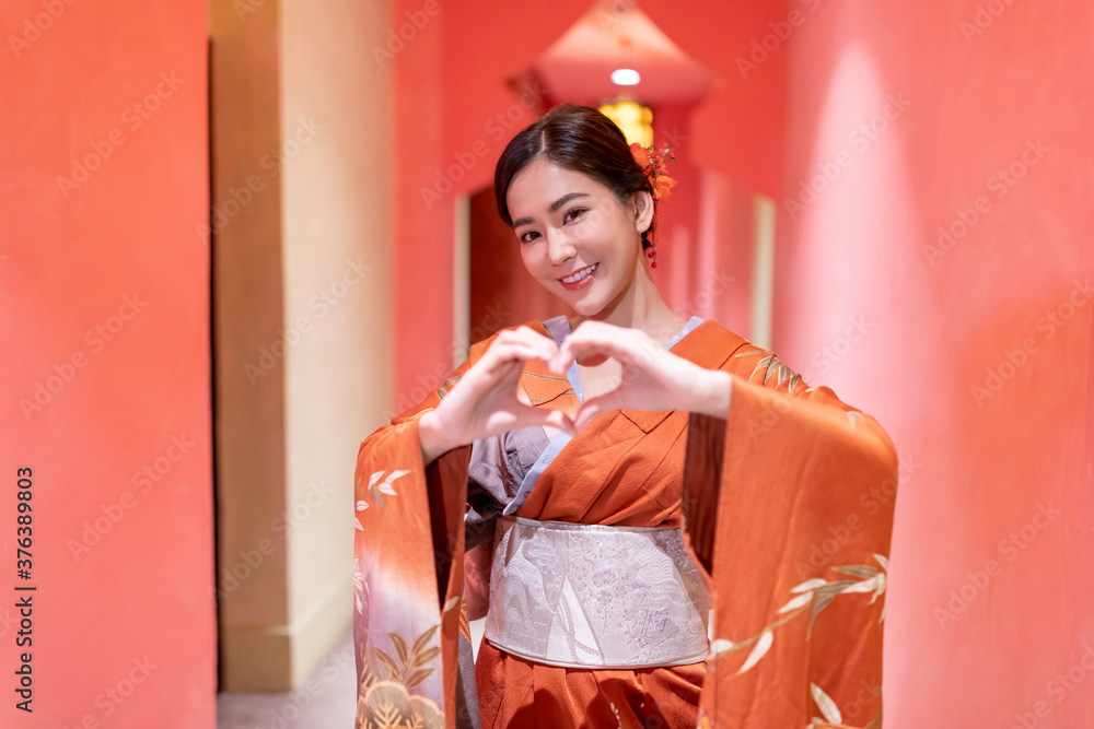 Asian beautiful women wearing red Japanese national costumes Making a ...