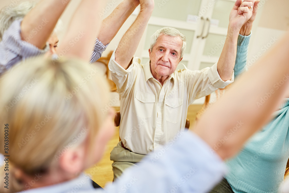Senior does an exercise with other retirees Stock Photo | Adobe Stock