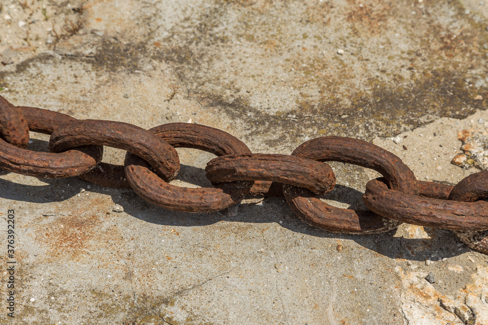 The old rusty metal chain of the anchor of the ship. Giant heavy steel ...