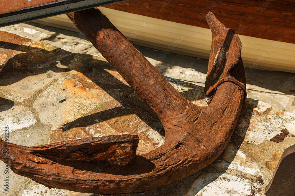 Rusty ancient anchor ship on the waterfront. Ancient forged rusty sea ...