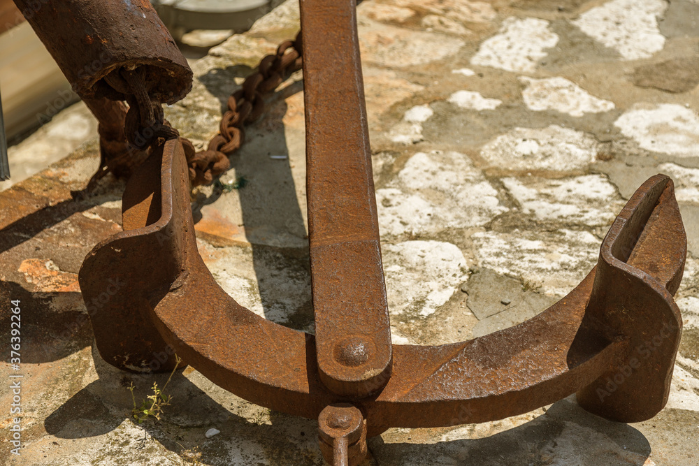 Rusty ancient anchor ship on the waterfront. Ancient forged rusty sea ...