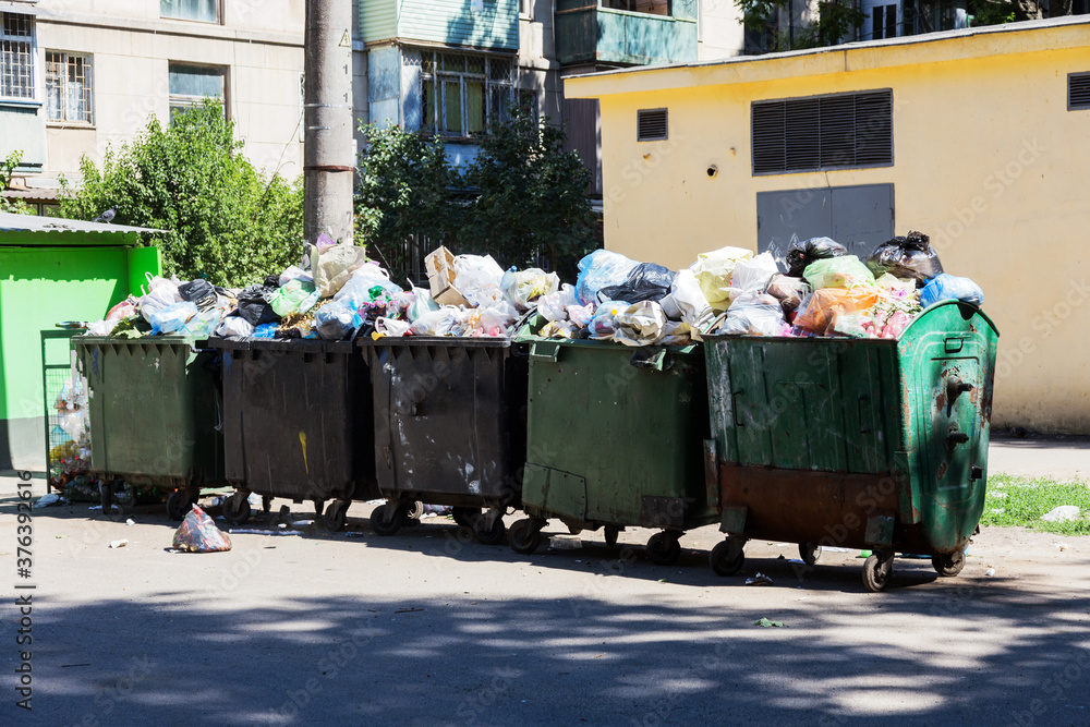 Overcrowded garbage containers with rubbish. Disused solid household ...