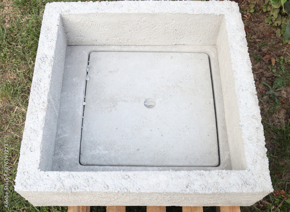 Square-shaped concrete manhole extension outdoors Stock Photo | Adobe Stock