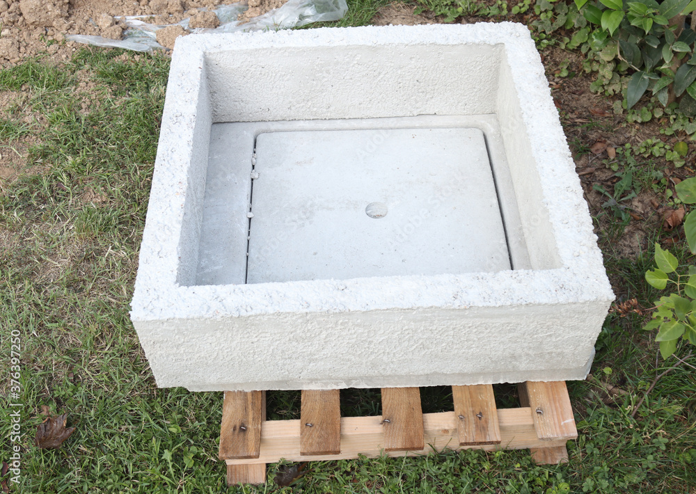 Square-shaped concrete manhole extension outdoors Stock Photo | Adobe Stock