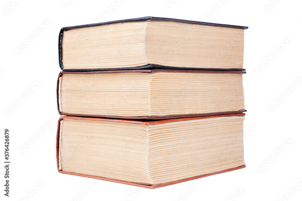 Three closed old thick paper books with yellow pages white background ...