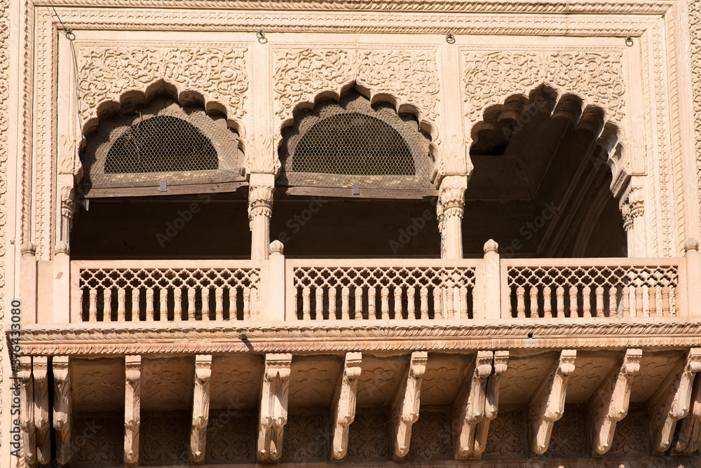 Exterior view of an ornately carved window and balcony on an old temple ...