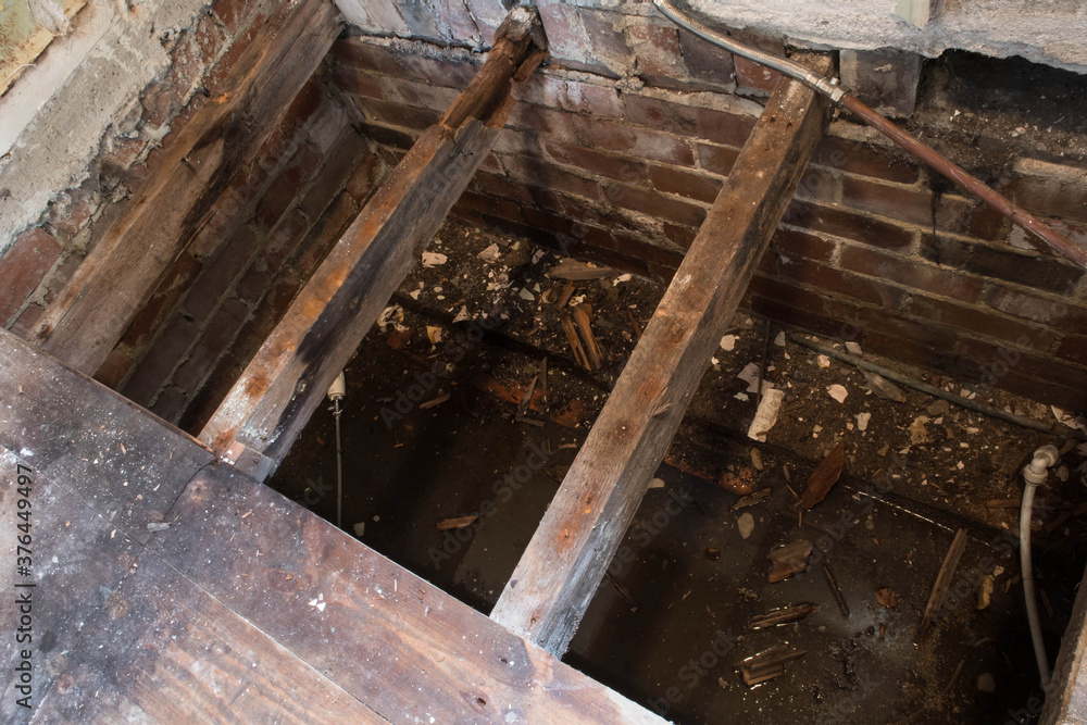 Rotton broken floor joists exposed during home renovation and building ...