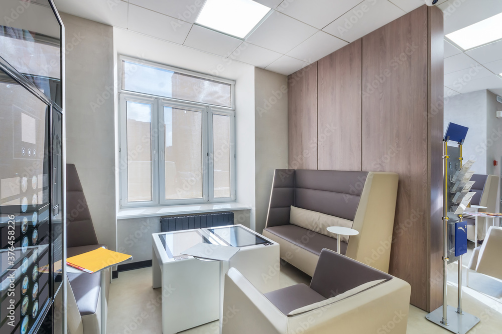 The waiting area with a vending coffee machine, soft leather sofas and ...