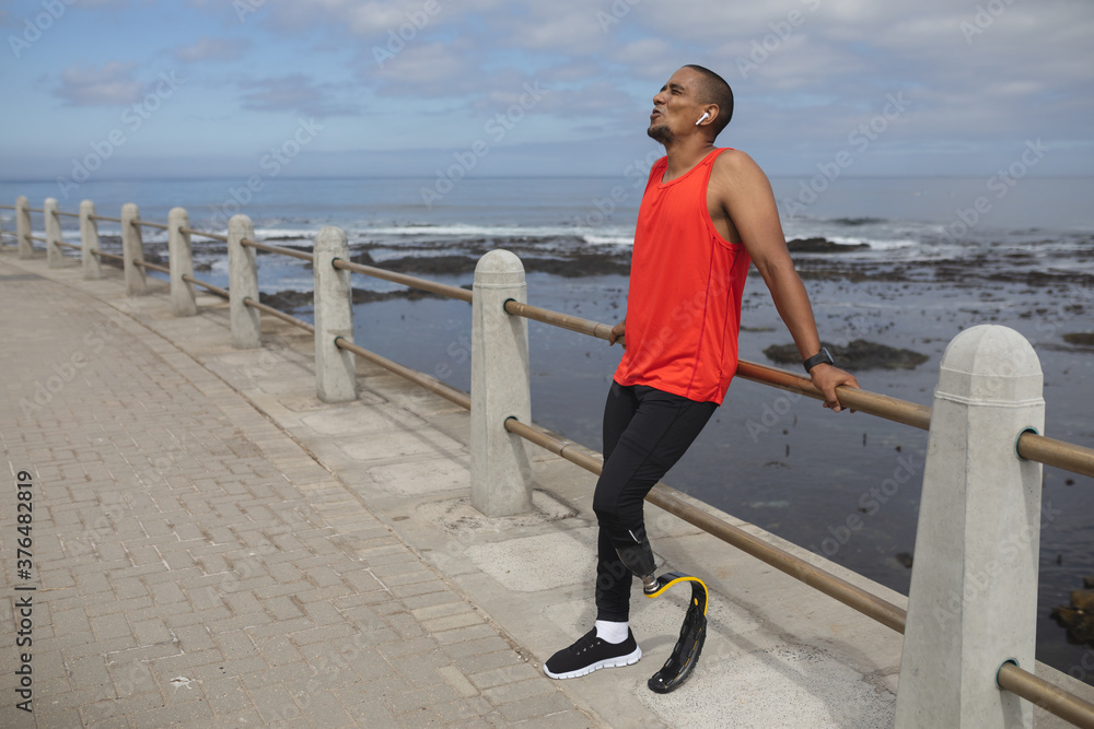 Black African American Man with prosthetic leg standing on the ...