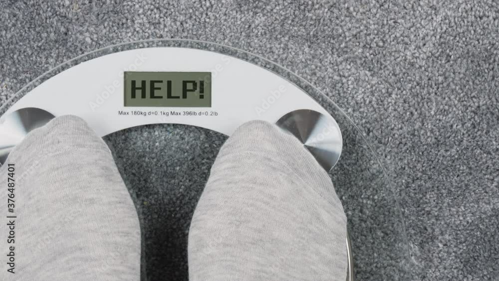 Overweight. Bathroom scales screen with inscription HELP. Health and ...