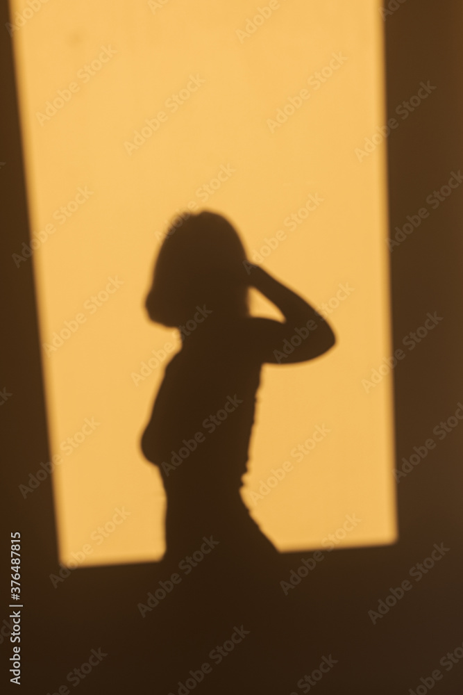 Sexy pretty woman shadow on the wall. Female silhouette in sunlight ...