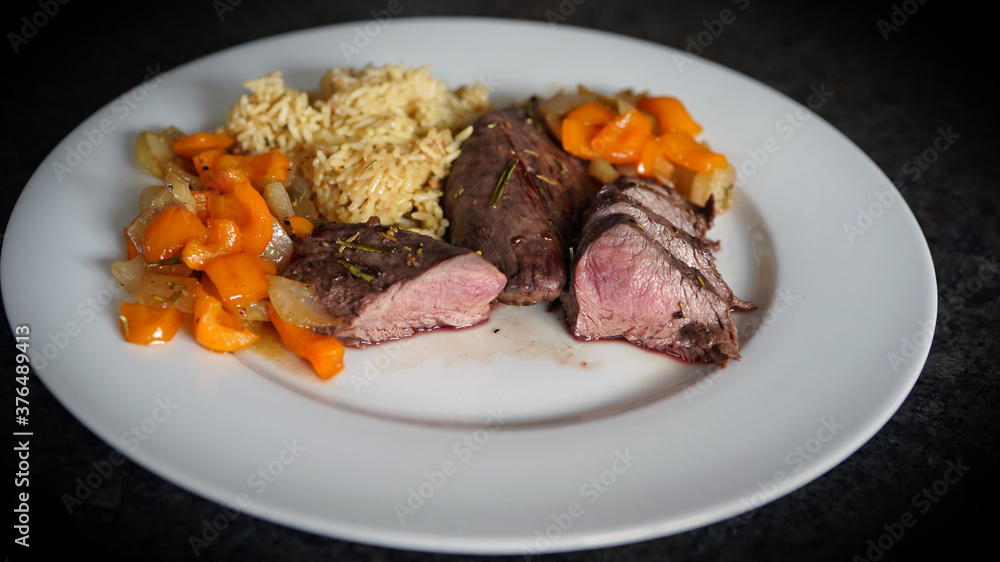 ready to eat - roasted fillet from a red deer calf with onions and ...