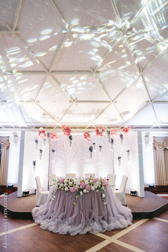Full view of beautiful wedding hall with decorated dim lavander table ...