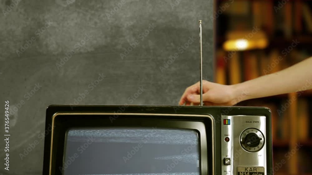Man adjusting the Antenna of an Old Television with Blue Screen. You ...