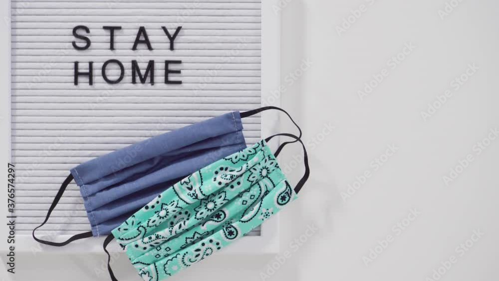 Vidéo Stock STAY HOME sign on message board with a homemade face mask ...