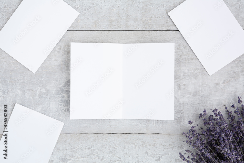 Four white greeting cards mockup on a white wooden desk. Blank, open ...