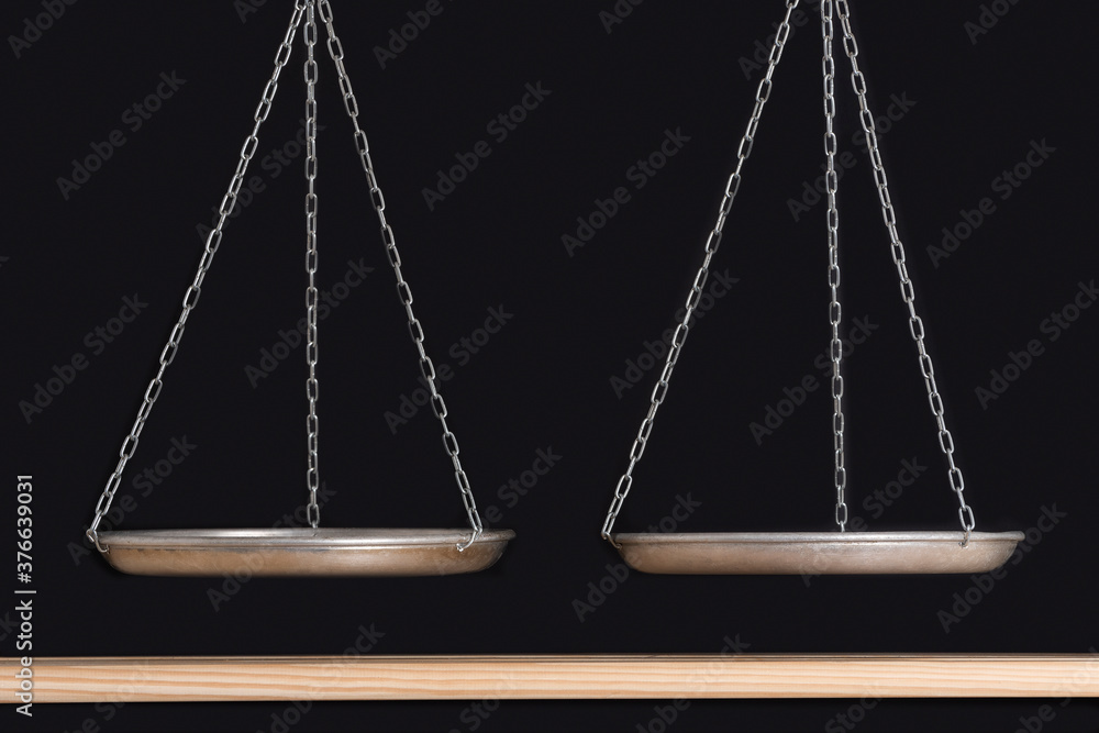Scales are in balance. Black background and wooden shelf. Balance ...