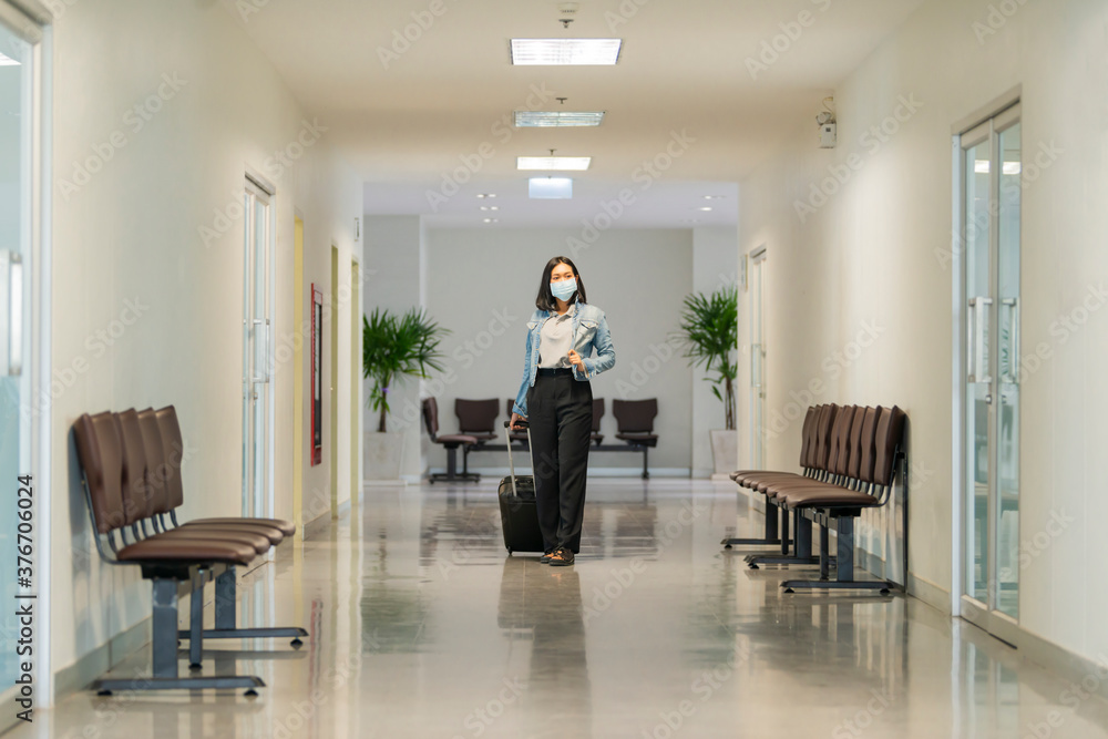 Full body profile portrait of Asian female traveler in protective masks against covid19, flu ...