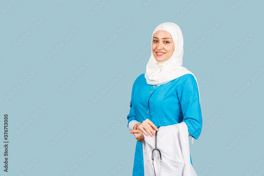 Portrait of a friendly, muslim doctor or nurse woman in hijab with a ...