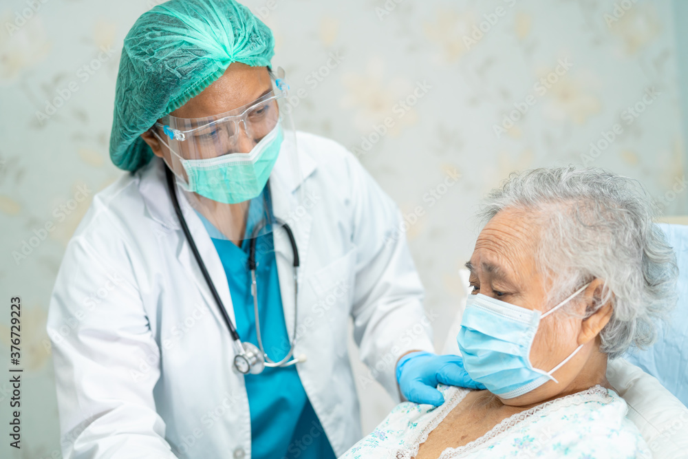 Asian doctor wearing face shield and PPE suit new normal to check ...