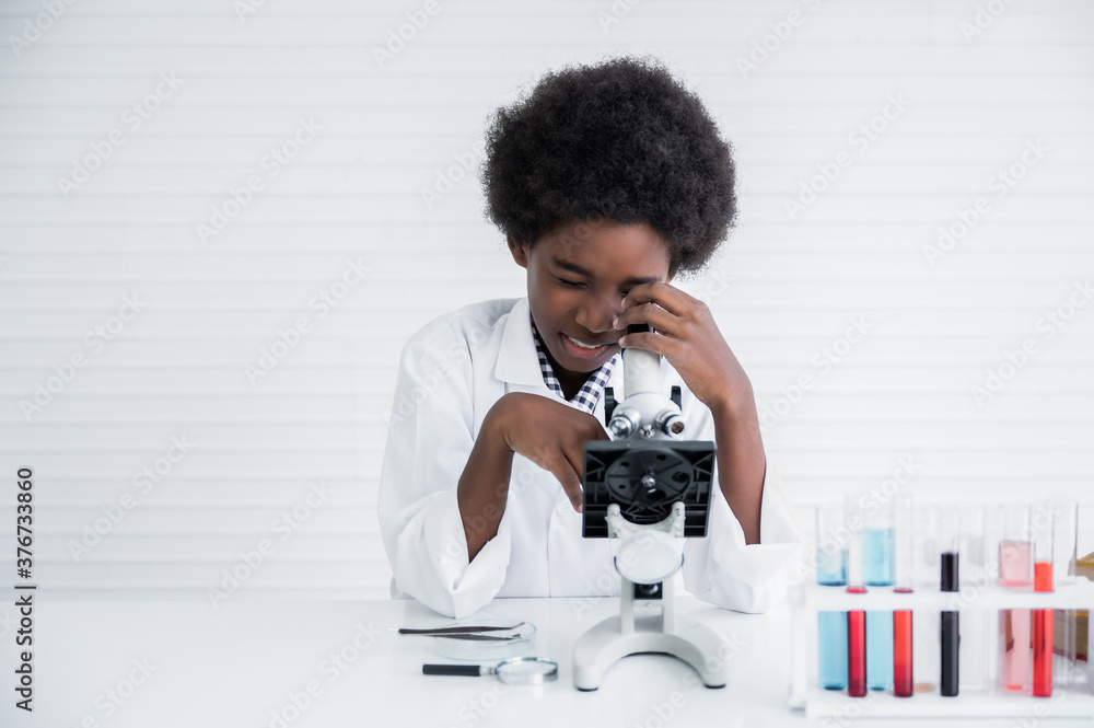Happy african child boy student is learning and test science chemical ...