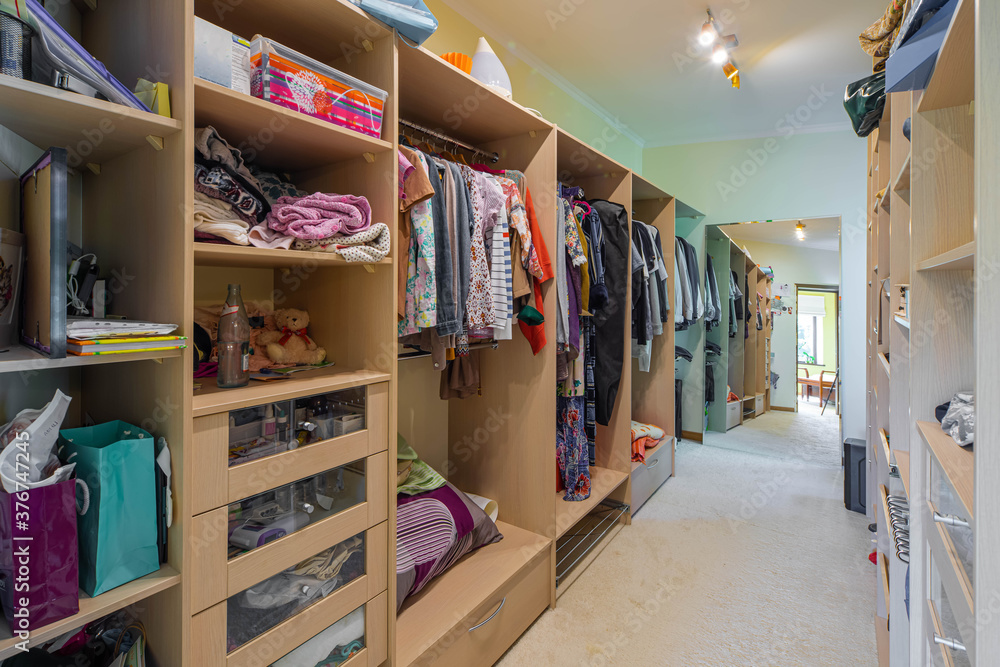 Dressing room in private house. Modern interior. Wooden wardrobe with ...