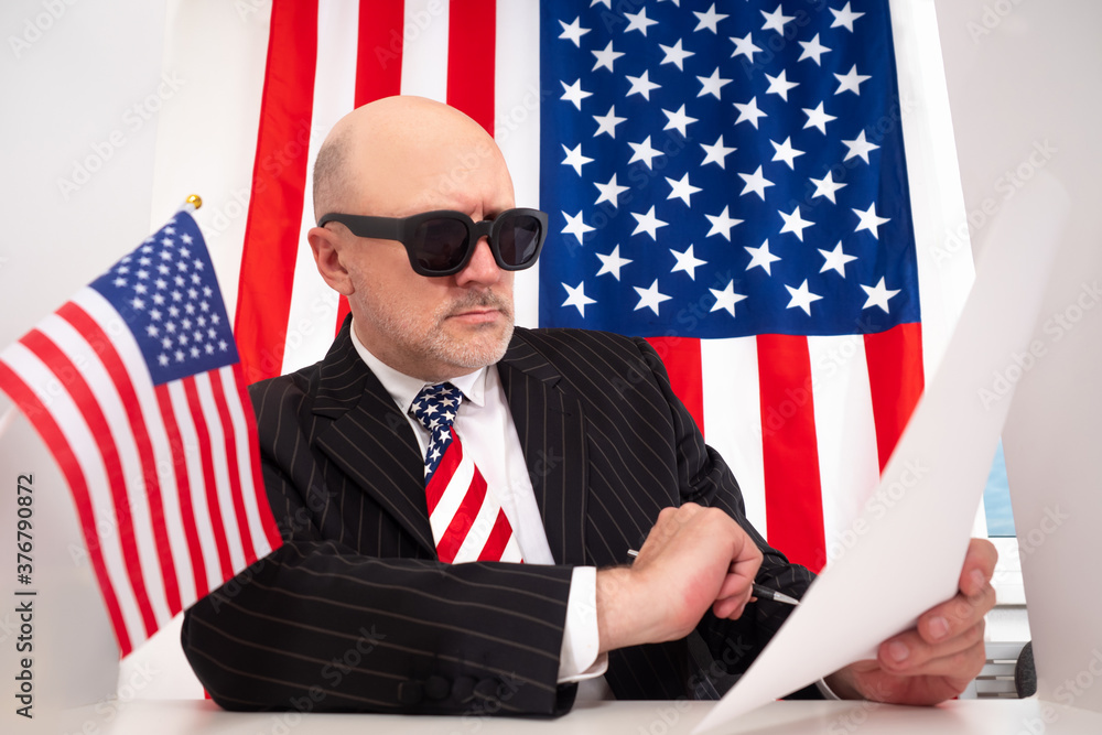 An American official with black glasses. The American bureaucracy. A ...