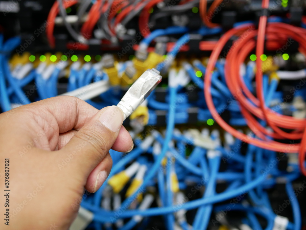 Technicians adjustment LAN cable network connected to internet switch ...