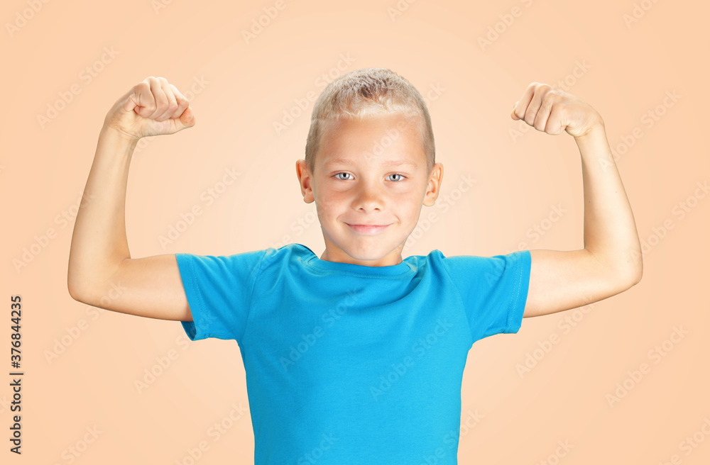 Funny boy showing his biceps muscles Stock Photo | Adobe Stock