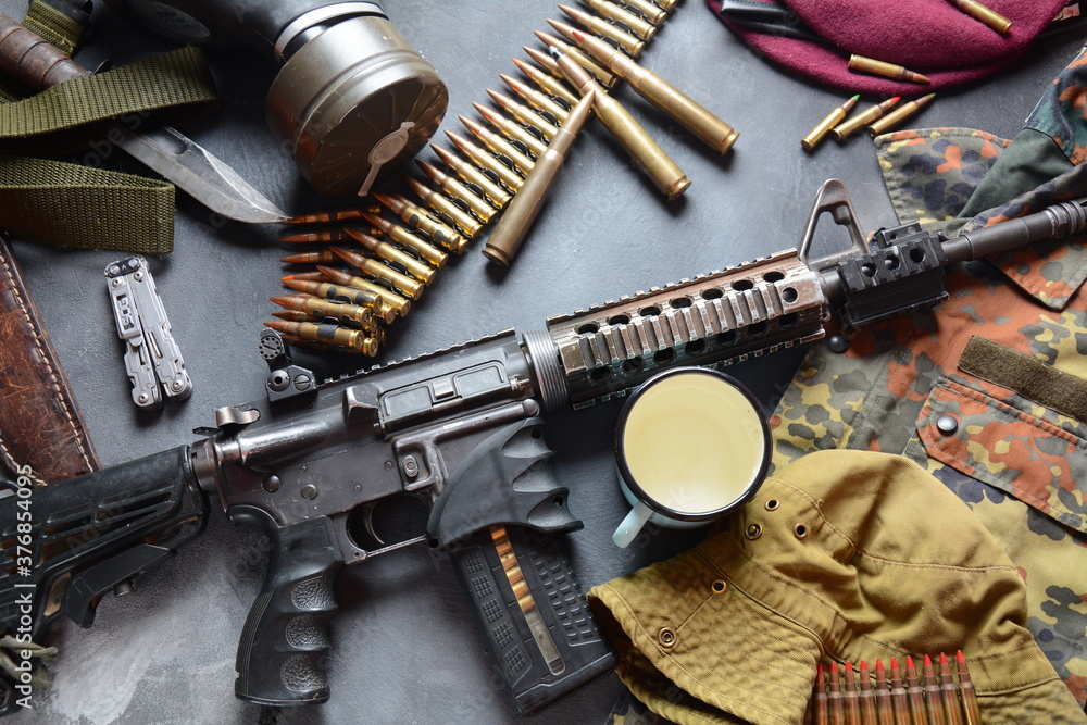 Assault rifle (M4A1) with ammunition on camouflage uniform,and military ...