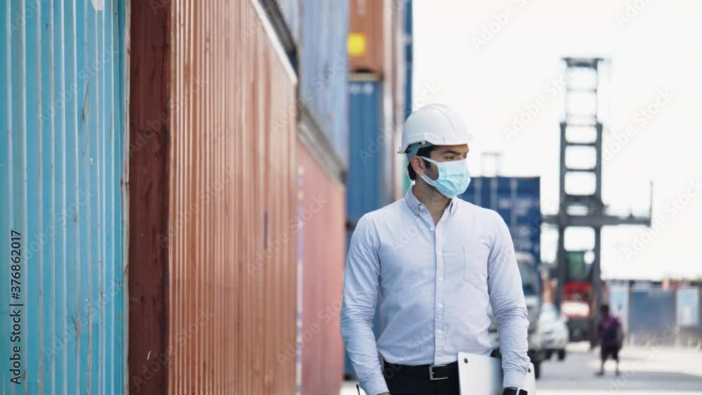 Engineer or construction worker wearing a hard hat and Face mask While ...