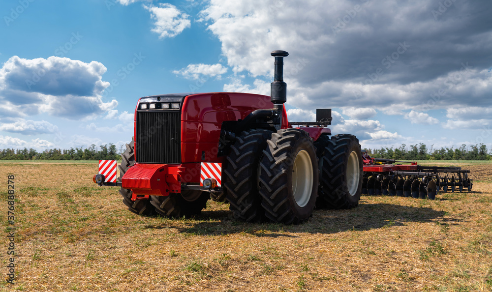 Autonomous unmanned tractor with plow working on the field. Smart ...