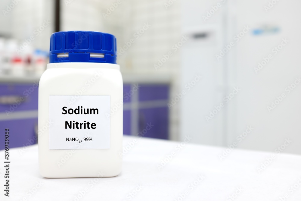 Selective focus of a bottle of sodium nitrite preservative chemical ...