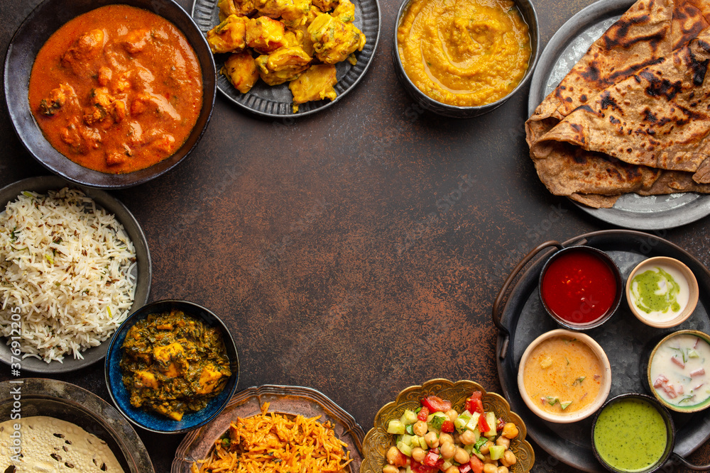 Variety of Indian food, different dishes and snacks on dark rustic ...