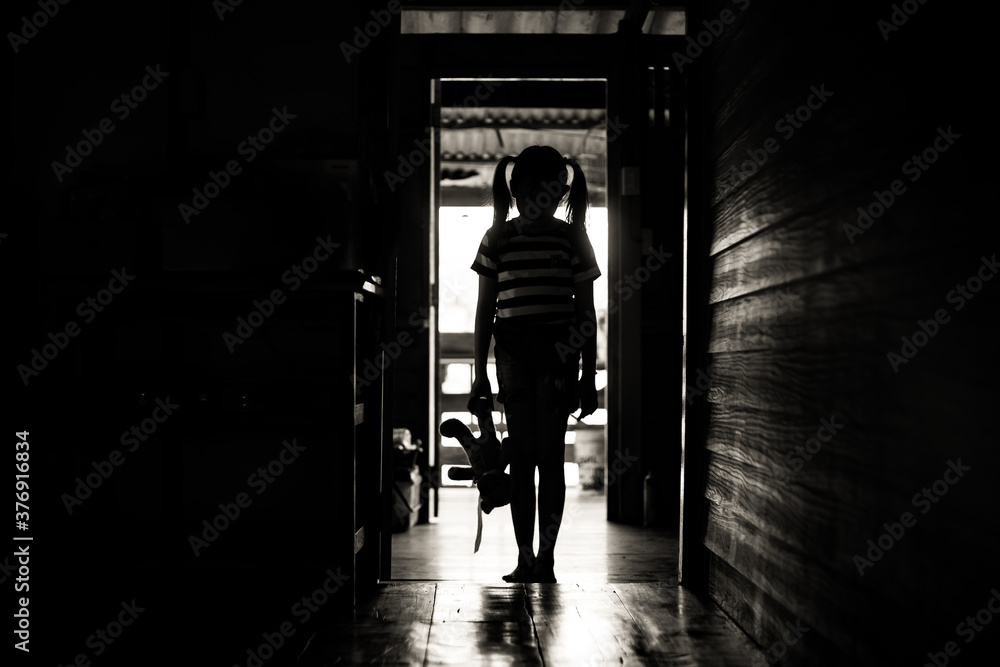 Alone little child girl standing and holding teddy bear with lonely and ...