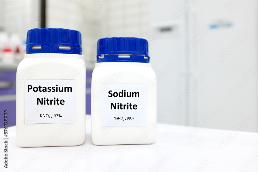 Selective focus of bottles of sodium nitrite and potassium nitrite ...