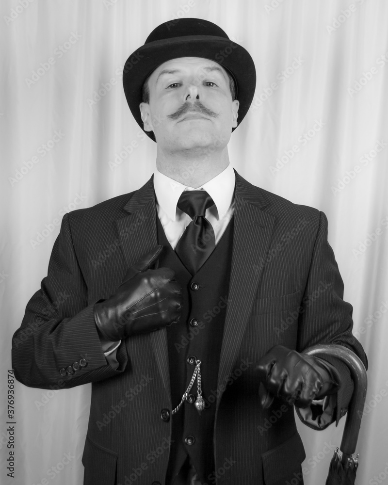 Elegant British Gentleman in Dark Suit and Leather Gloves Holding an ...