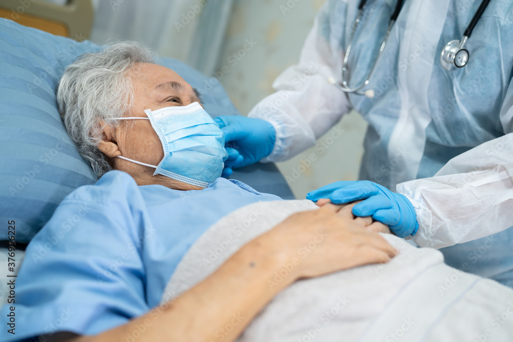 Asian doctor wearing face shield and PPE suit new normal to check ...