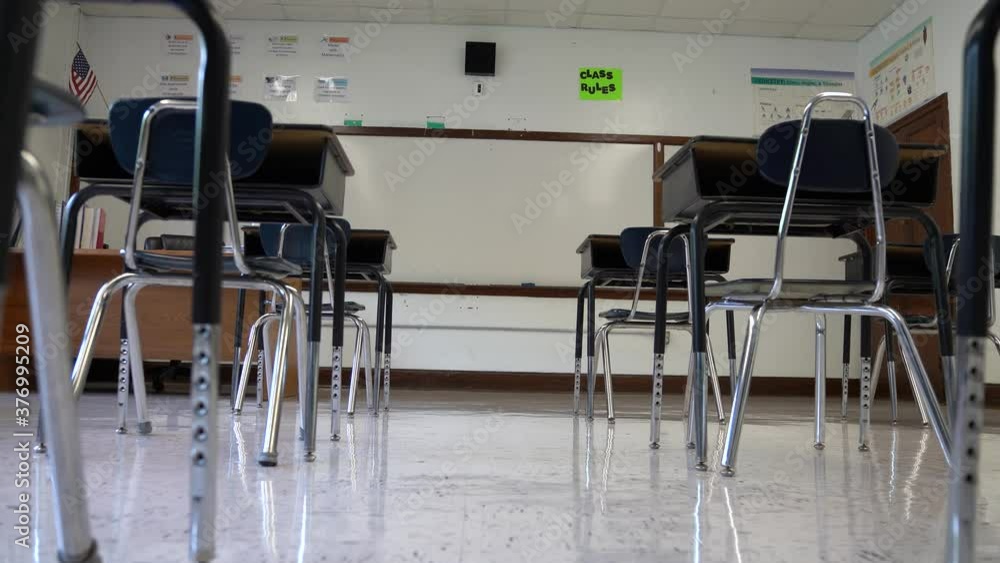 Floor view motion to the right showing empty school classroom with ...