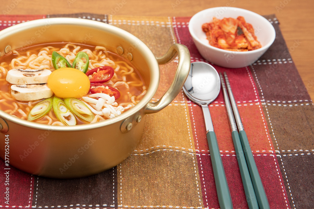 Serving a Korean style instant noodle, Ramyeon with egg yolk, chilli ...