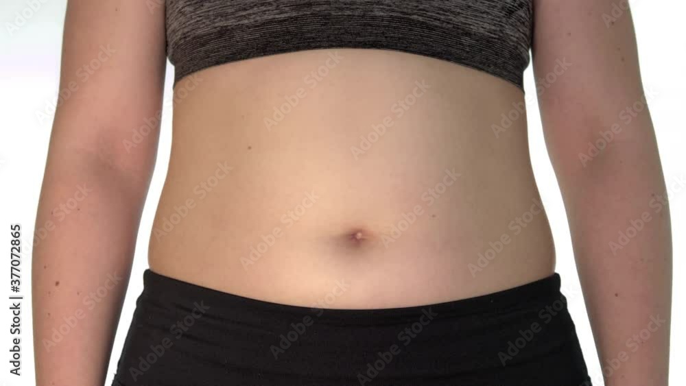 Video „A close-up of a woman's belly with a visible navel. Young woman ...
