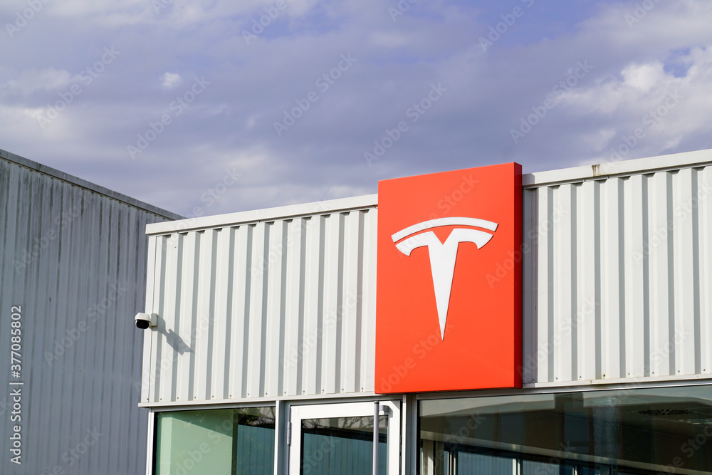 Tesla car red logo sign front of ev dealership showroom cars shop Stock ...