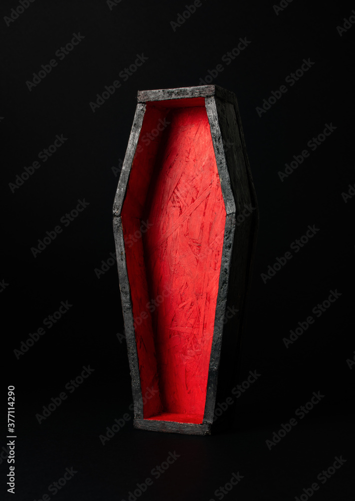 Miniature open black-red coffin on a black background. Festive ...