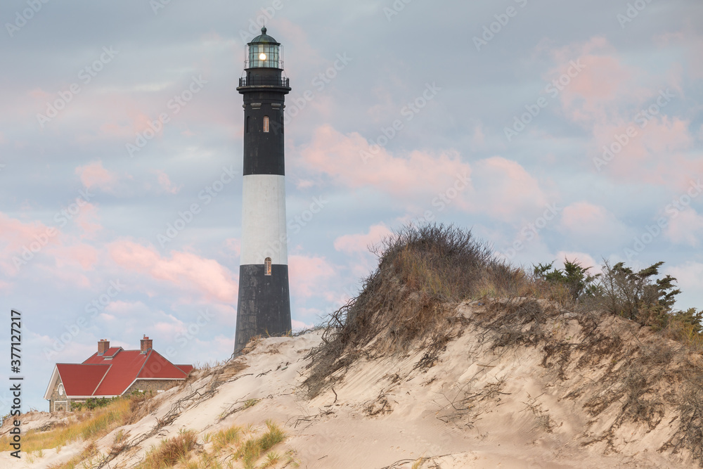 The Fire Island Lighthouse during a beautiful sunset filled with ...