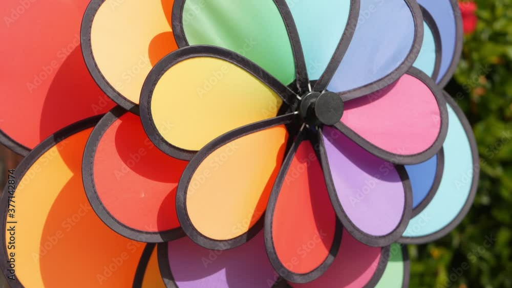 Colorful pinwheel spinning, weather wind vane, garden decoration in USA ...