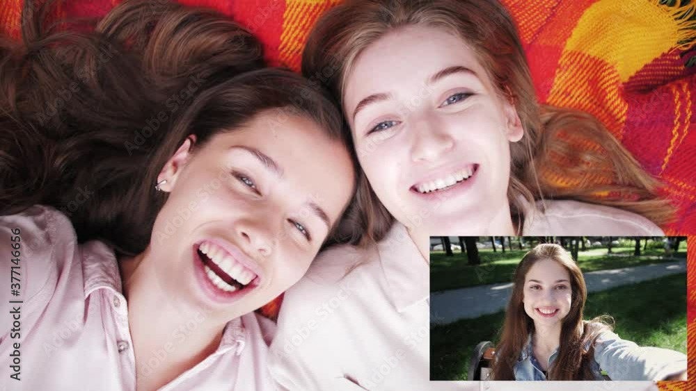 Young women using video conference for video call outdoor in the park ...