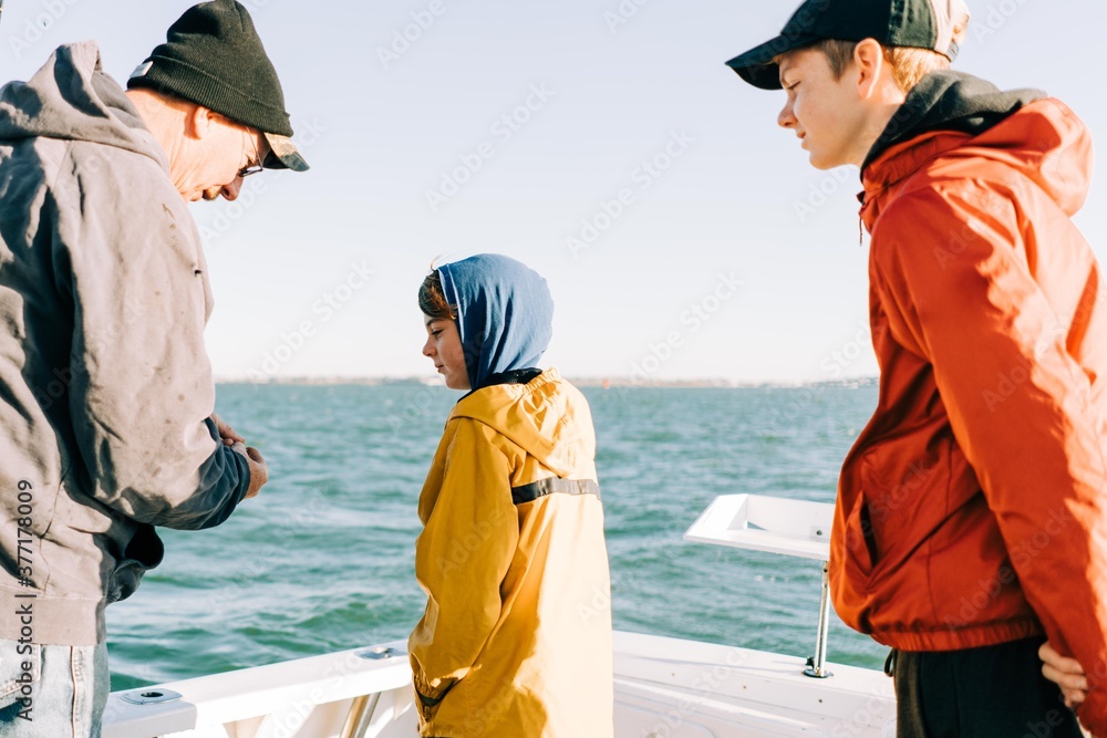 fisherman teaching kids to fish Stock Photo | Adobe Stock