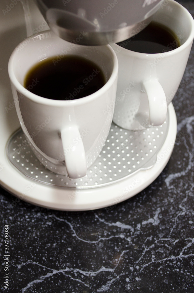 Two cups of coffee top view. Process of espresso making with usage of ...