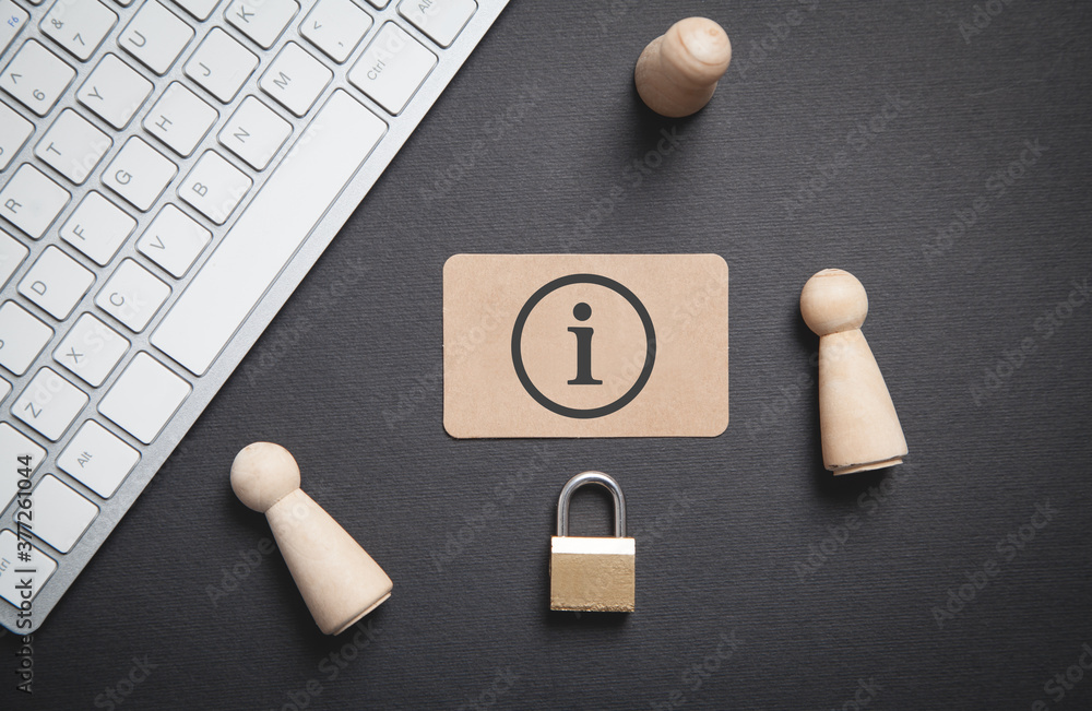 Information symbol with a computer keyboard, padlock and wooden human ...